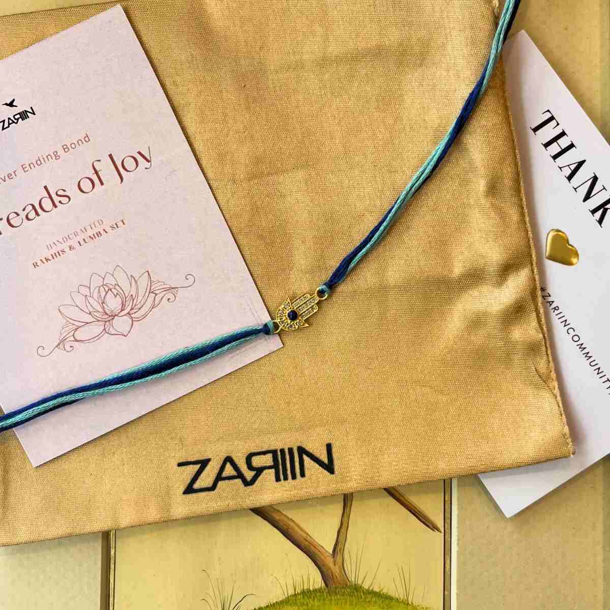 Symbol of Protection Hamsa Hand Rakhi – Zariin International